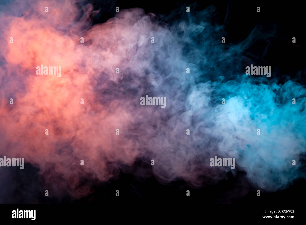 Multicolored smoke from a vape of blue and purple color of the exhaled ...