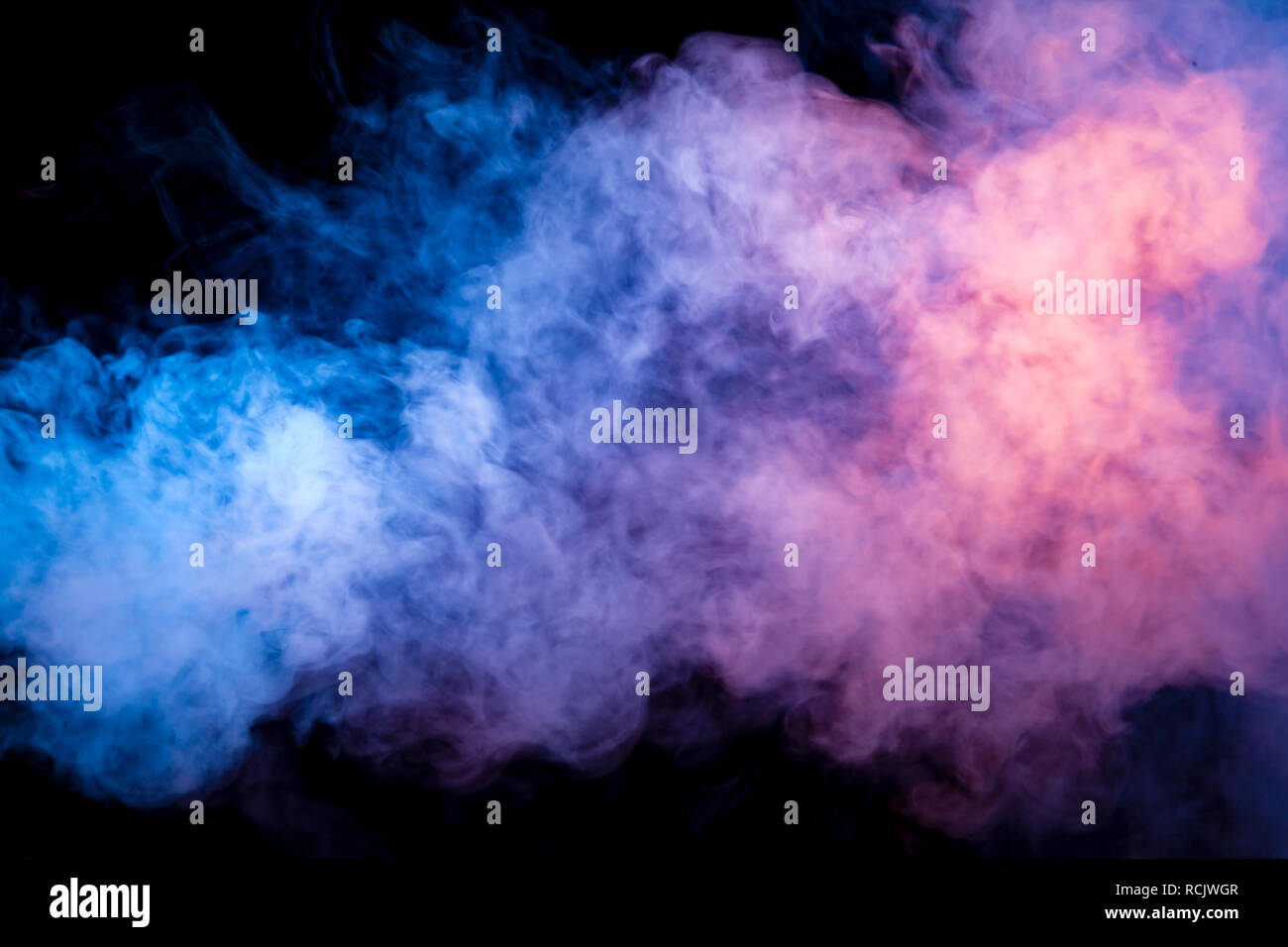 Multicolored smoke from a vape of blue and purple color of the strange ...