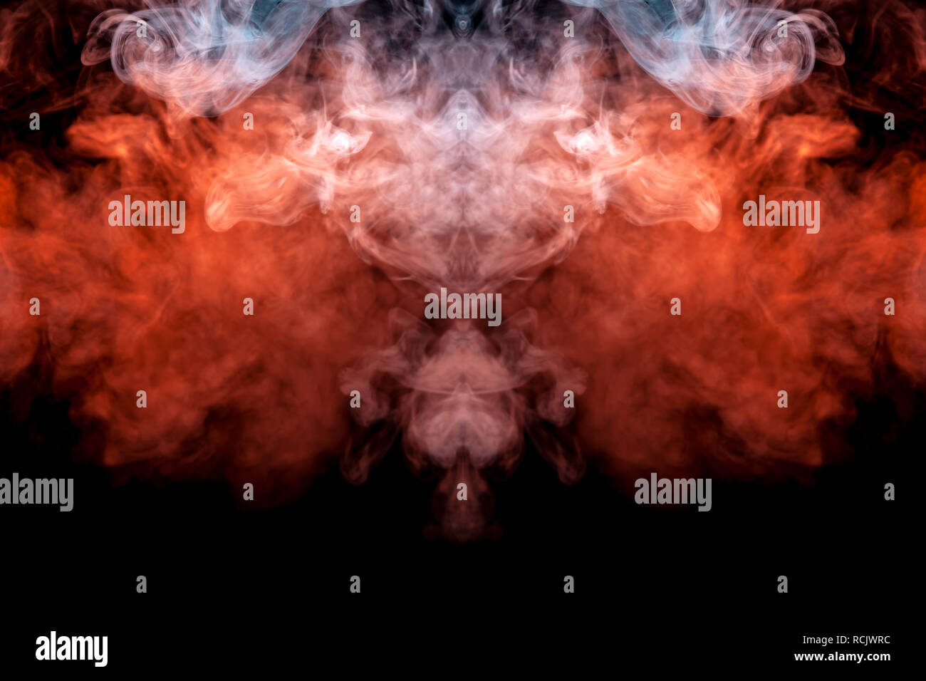 The explosion of fiery clouds of orange smoke on a black background jet ...