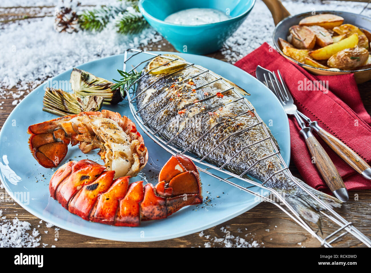 Close up view of barbecued fish on plate with lobster Stock Photo - Alamy