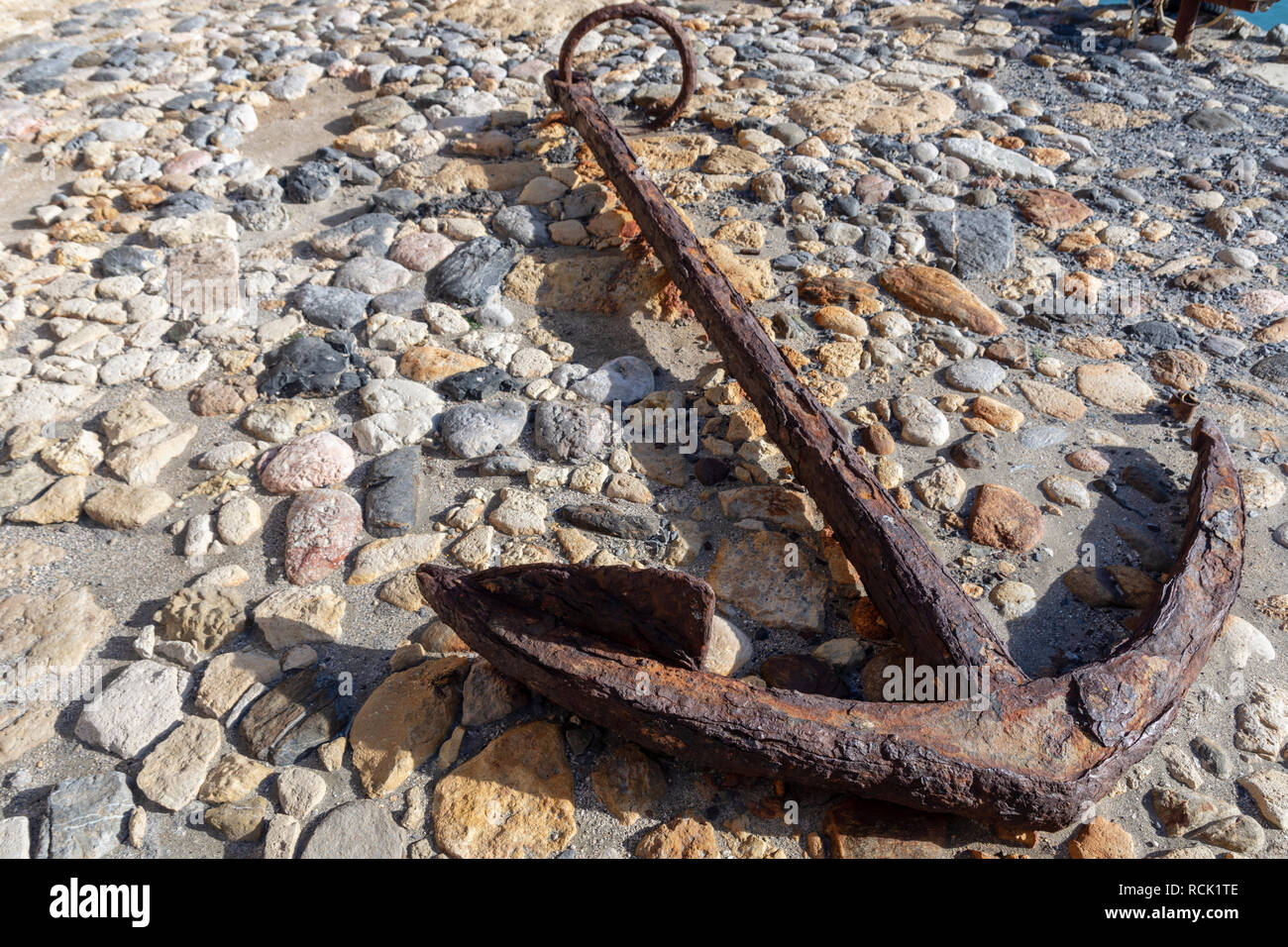 Old rusty anchor laying at the shore, picture from Heraklion Crete ...