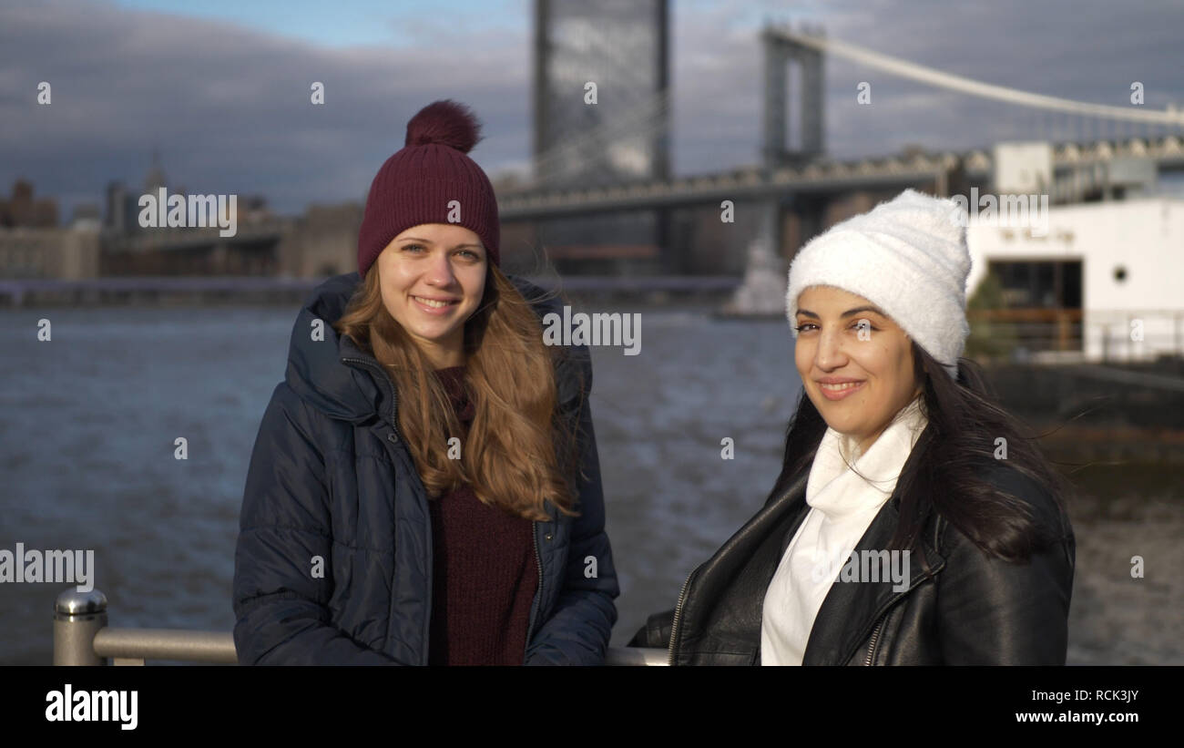 Two friends travel to New York for sightseeing at Brooklyn Bridge Stock ...