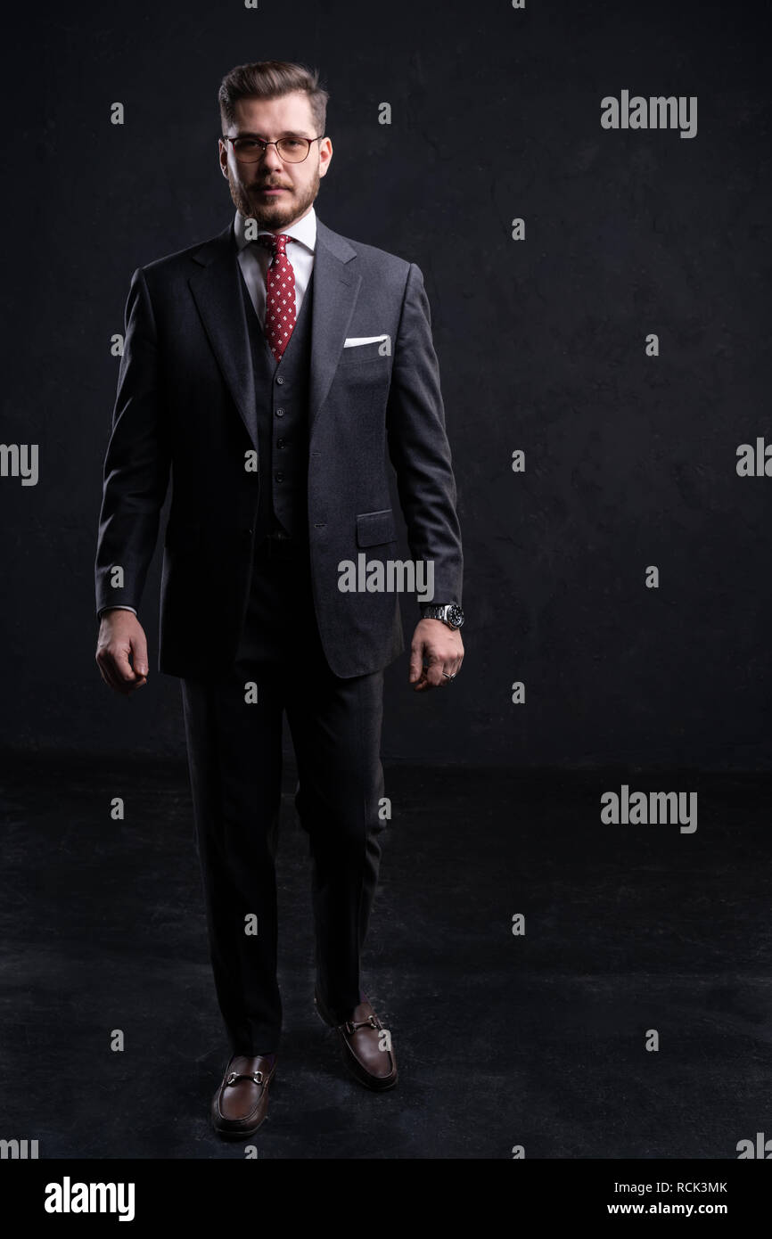 Full length portrait of a fashion male model over black background ...
