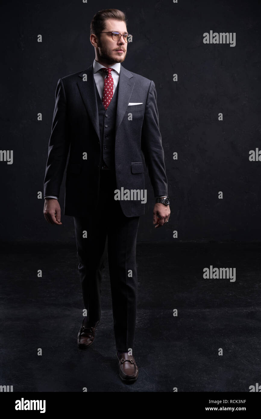 Full length portrait of a fashion male model over black background ...