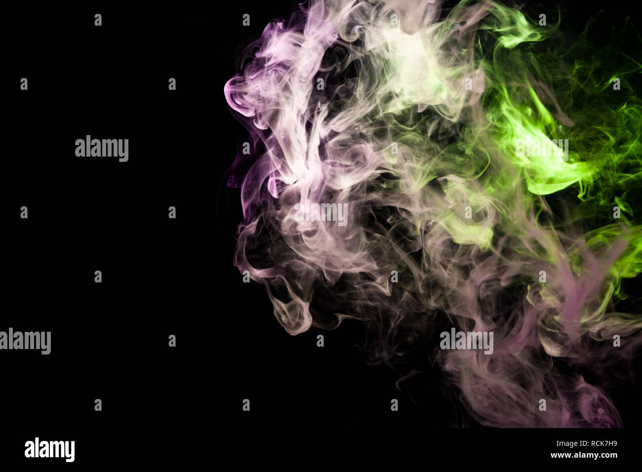 Thick pink and green smoke on a black isolated background. Background ...