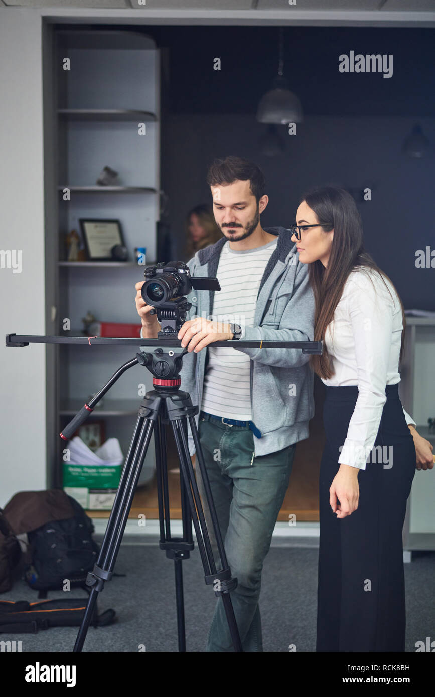 Cameraman showing the footage to the actor in the office scene ...