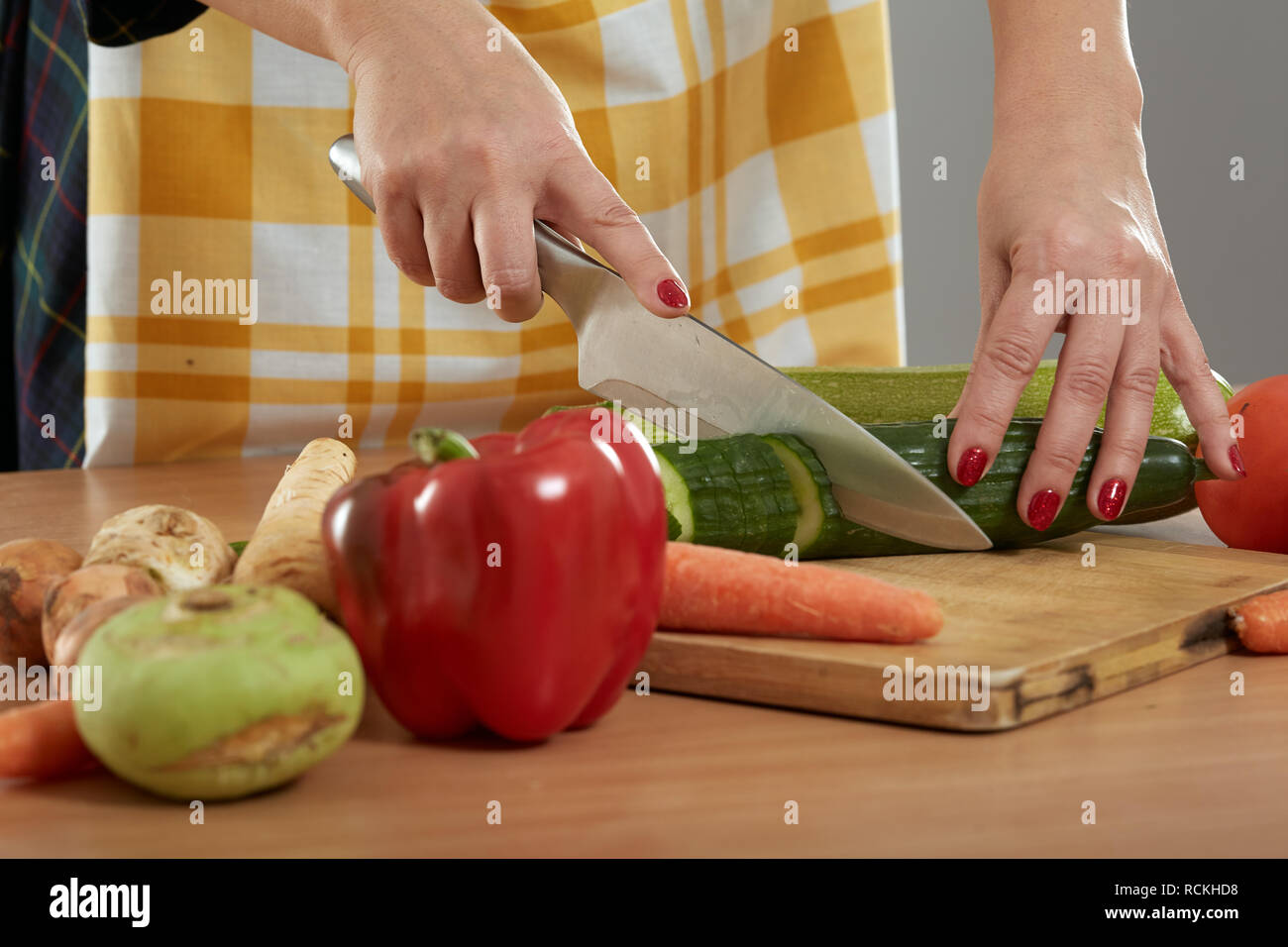Woman's hands chopping a variety of vegetables on a wooden board Stock ...
