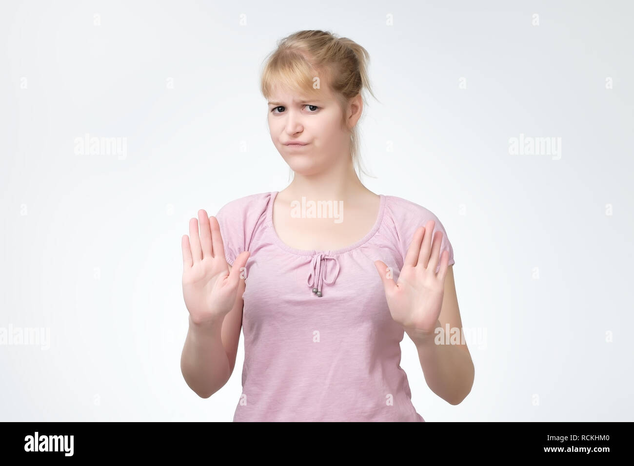 young girl is making stop sign, girl showing stop isolated on a white ...