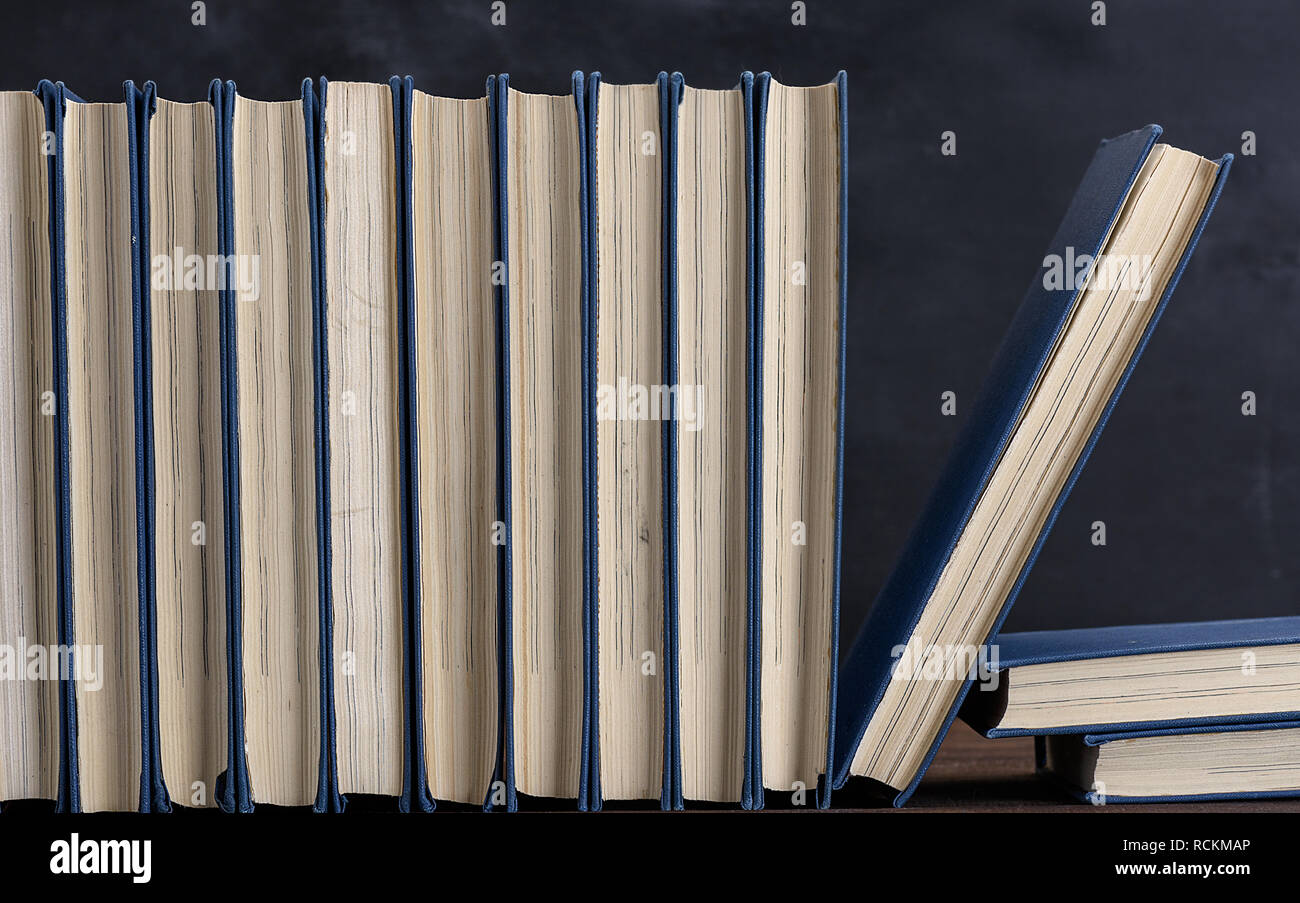books with blue cover, black background, close up Stock Photo - Alamy