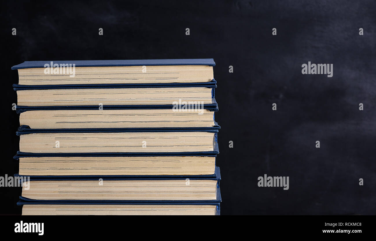 books with blue cover, black background, empty space Stock Photo - Alamy