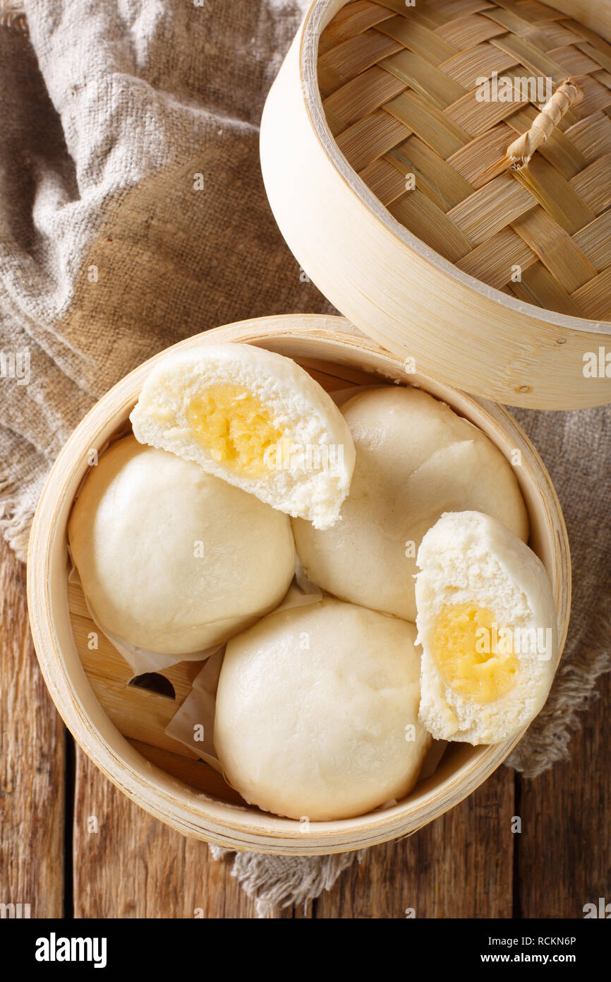Chinese Steamed Creamy Custard Bun close-up on the table. Vertical top ...