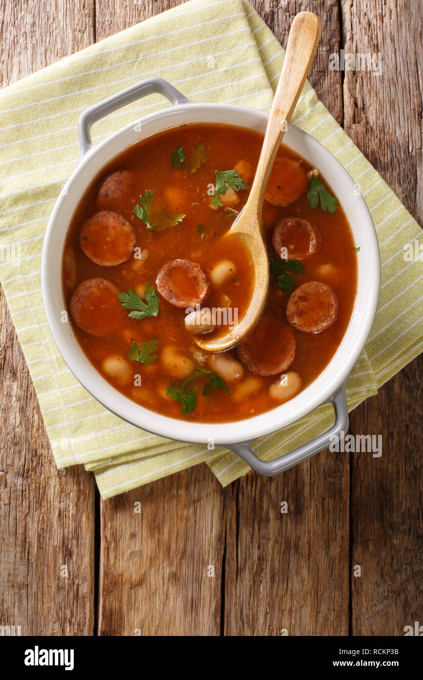 Rustic style Polish Breton beans with sausage close-up in a saucepan on ...