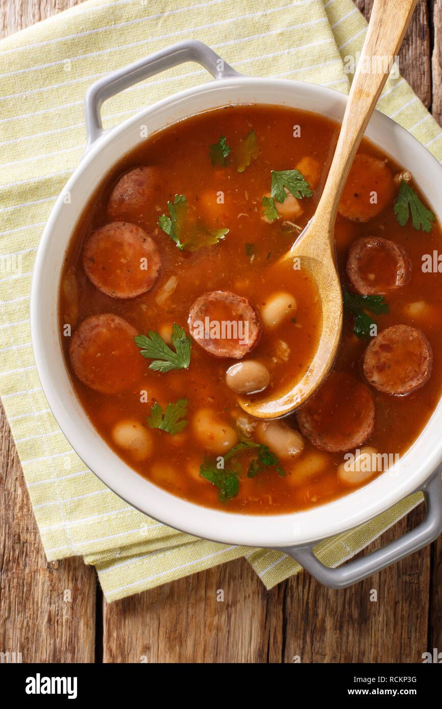Polish cuisine Breton beans with sausage close-up in a pan on the table ...