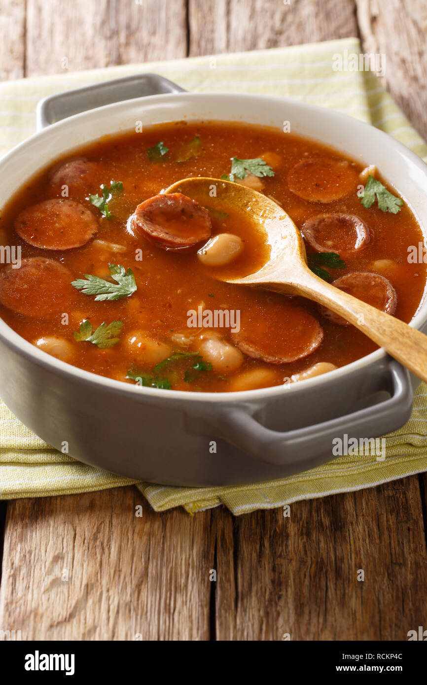 Rustic style Polish Breton beans with sausage close-up in a saucepan on ...