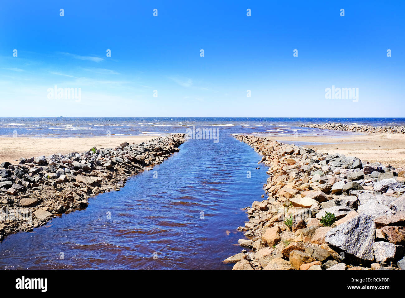 water channel, flowing into the sea, rocky beach. seascape Stock Photo ...
