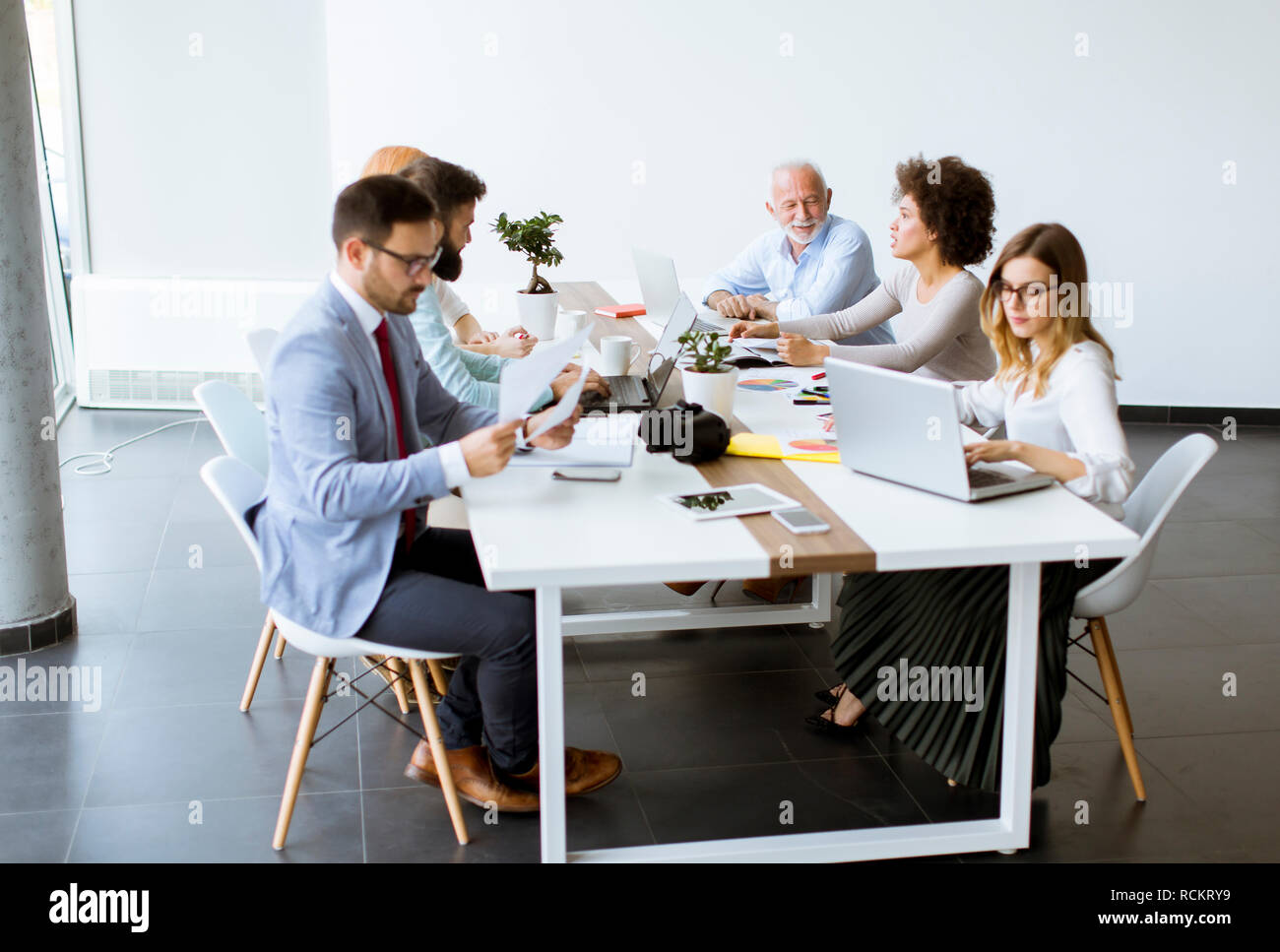 View of multiracial business people around table during staff meeting ...