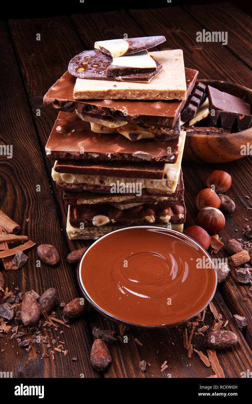 Chocolate bars on table with chocolate tower. Chocolate and nuts and ...