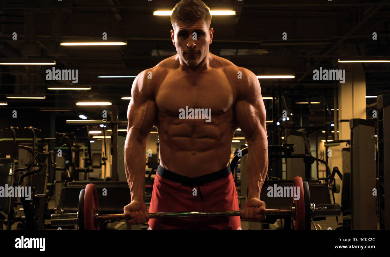 Athlete man with barbell doing exercise on biceps Stock Photo - Alamy