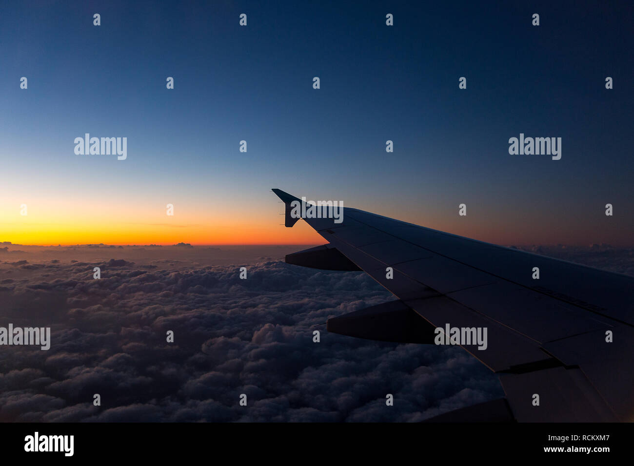 Plane fly clouds Stock Photo - Alamy