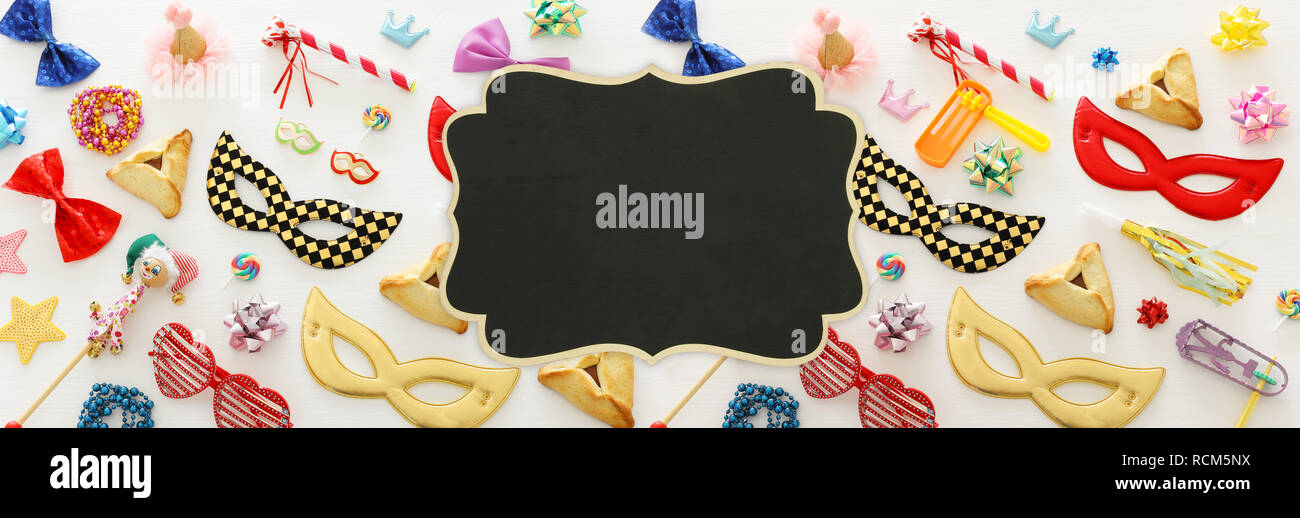 Purim celebration concept (jewish carnival holiday) over wooden white ...