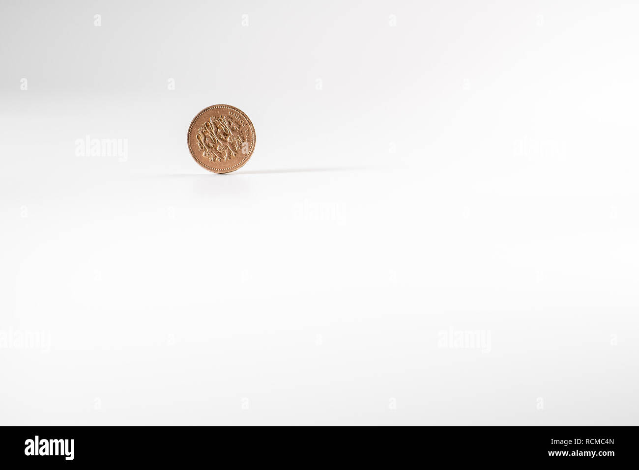 1 British pound coin falling on white background, isolated Stock Photo ...
