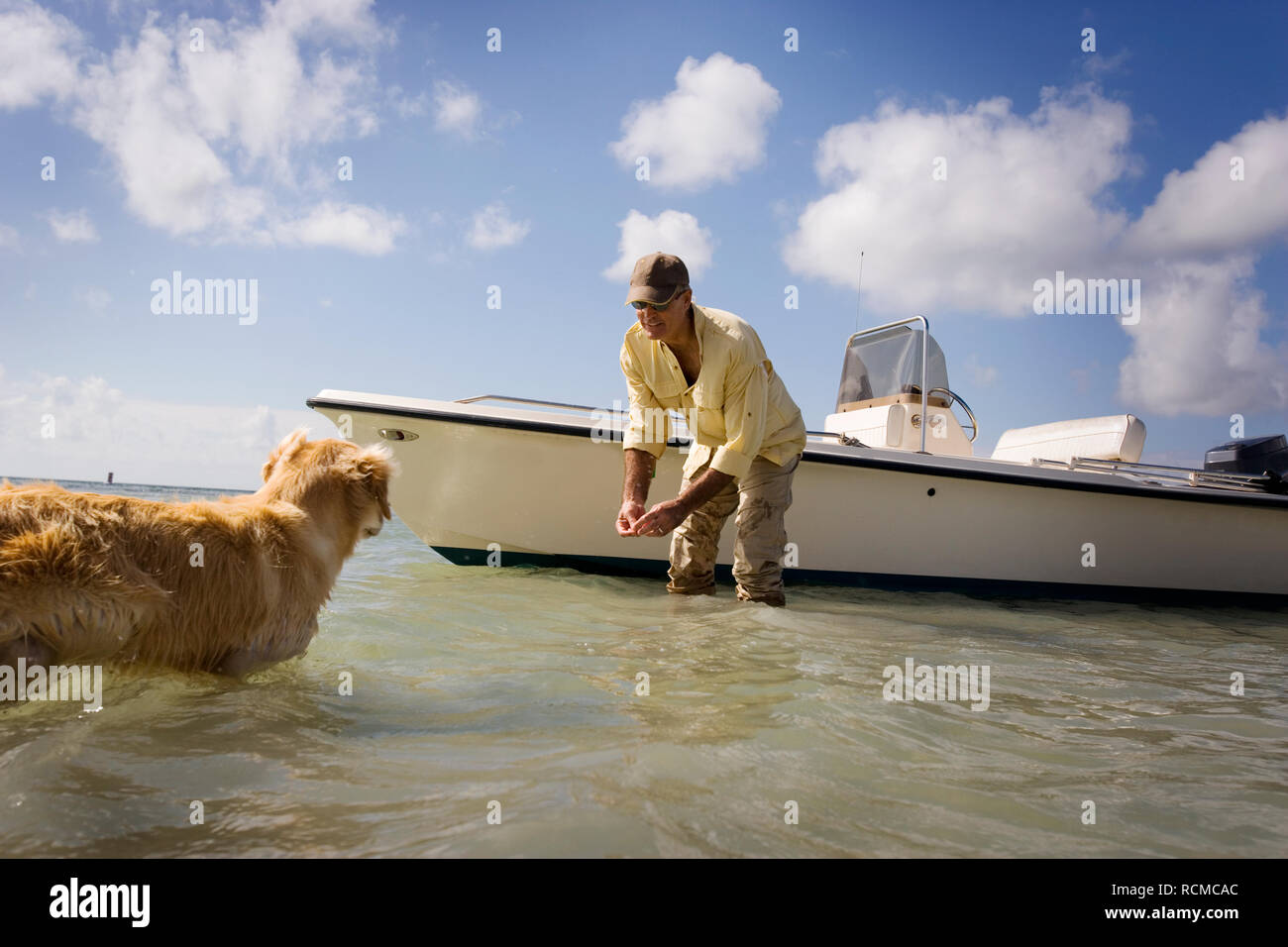 Man standing beside a boat hi-res stock photography and images - Alamy
