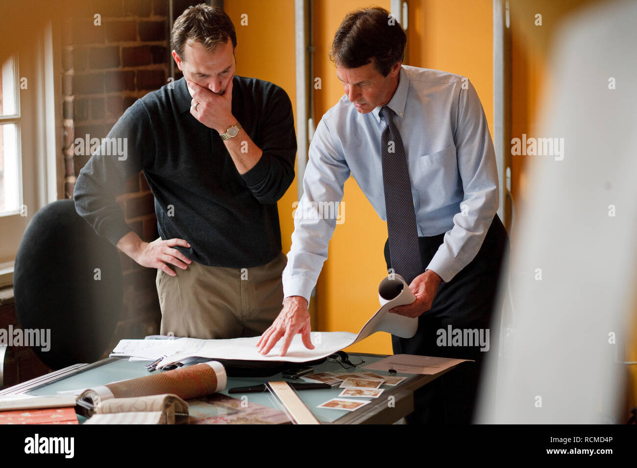 Two men discussing building plans Stock Photo - Alamy