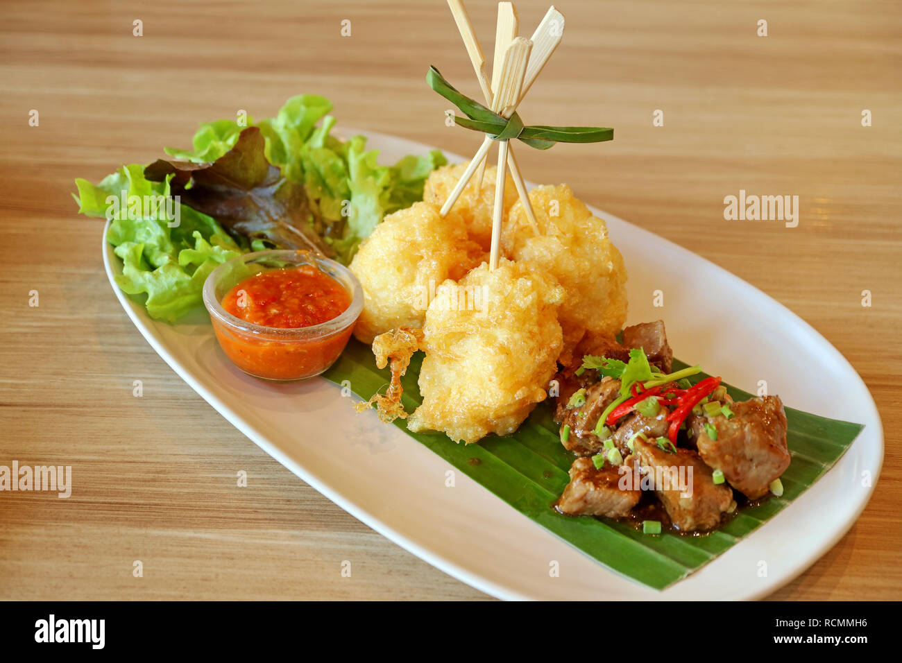 A Plate of Sauteed Beef and Deep Fried Sticky Rice Balls with Fresh ...