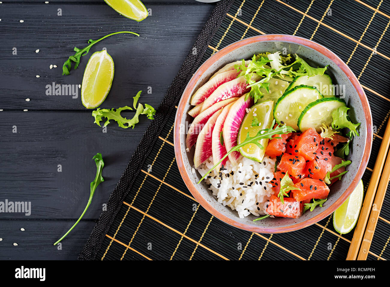 Hawaiian salmon fish poke bowl with rice, cucumber, radish, sesame ...