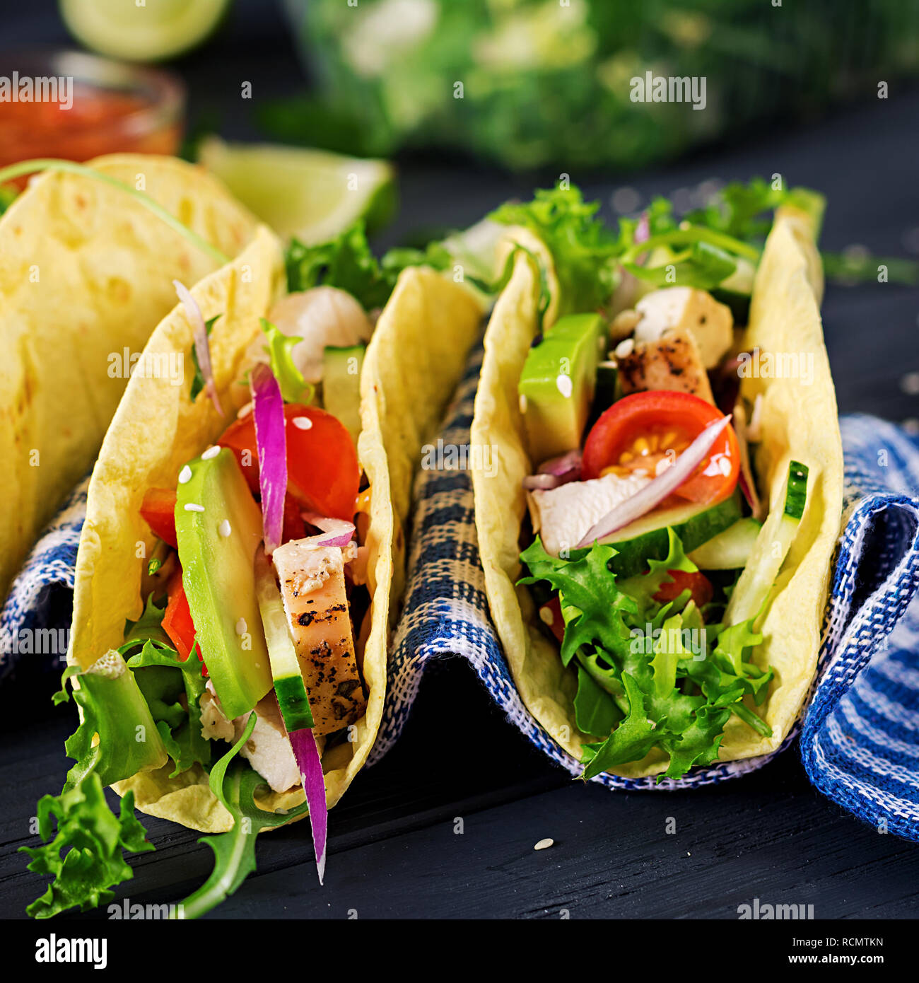 Mexican tacos with chicken meat, avocado, tomato, cucumber and red ...