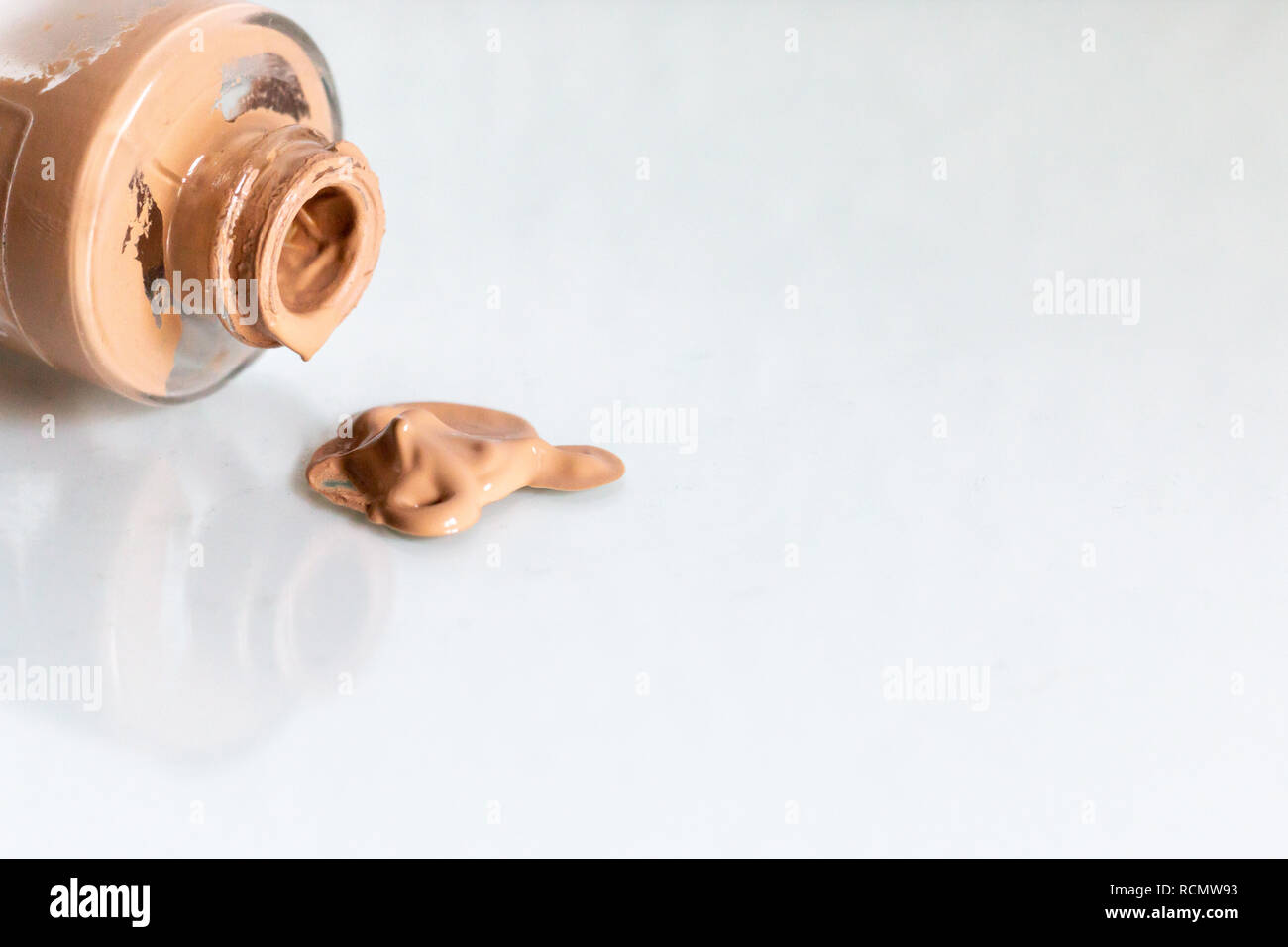 Blob of foundation makeup being poured from a bottle Stock Photo - Alamy