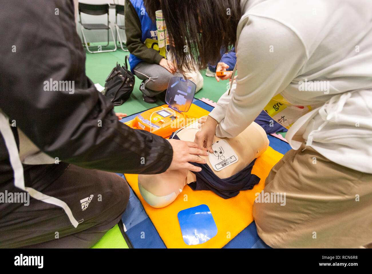 Foreign residents participate in a first aid class during the Disaster ...
