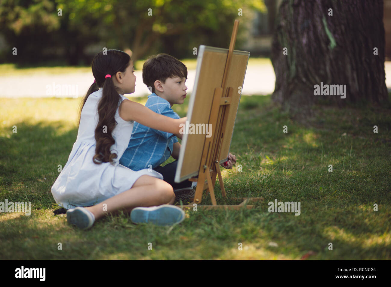 Happy children studying outside Stock Photo - Alamy