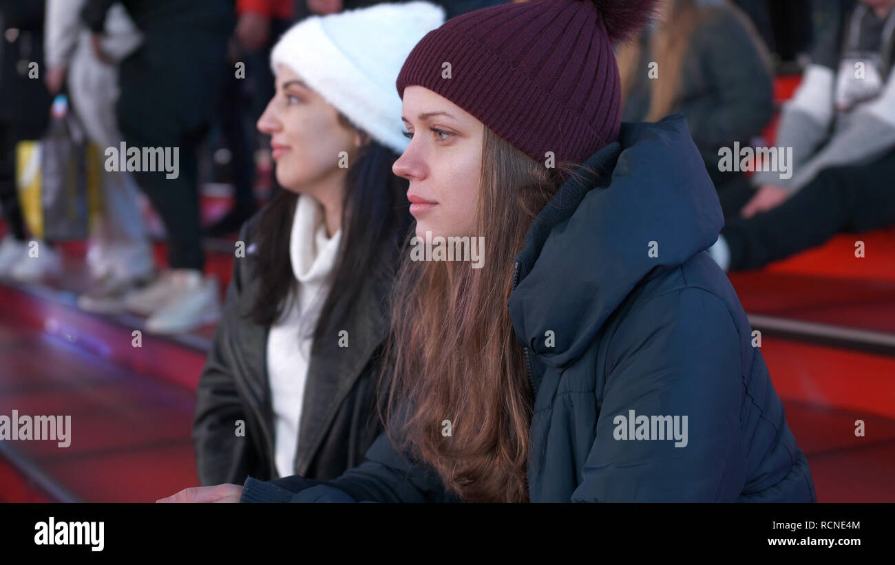Two girls at Times Square by night sit on the famous red steps Stock ...
