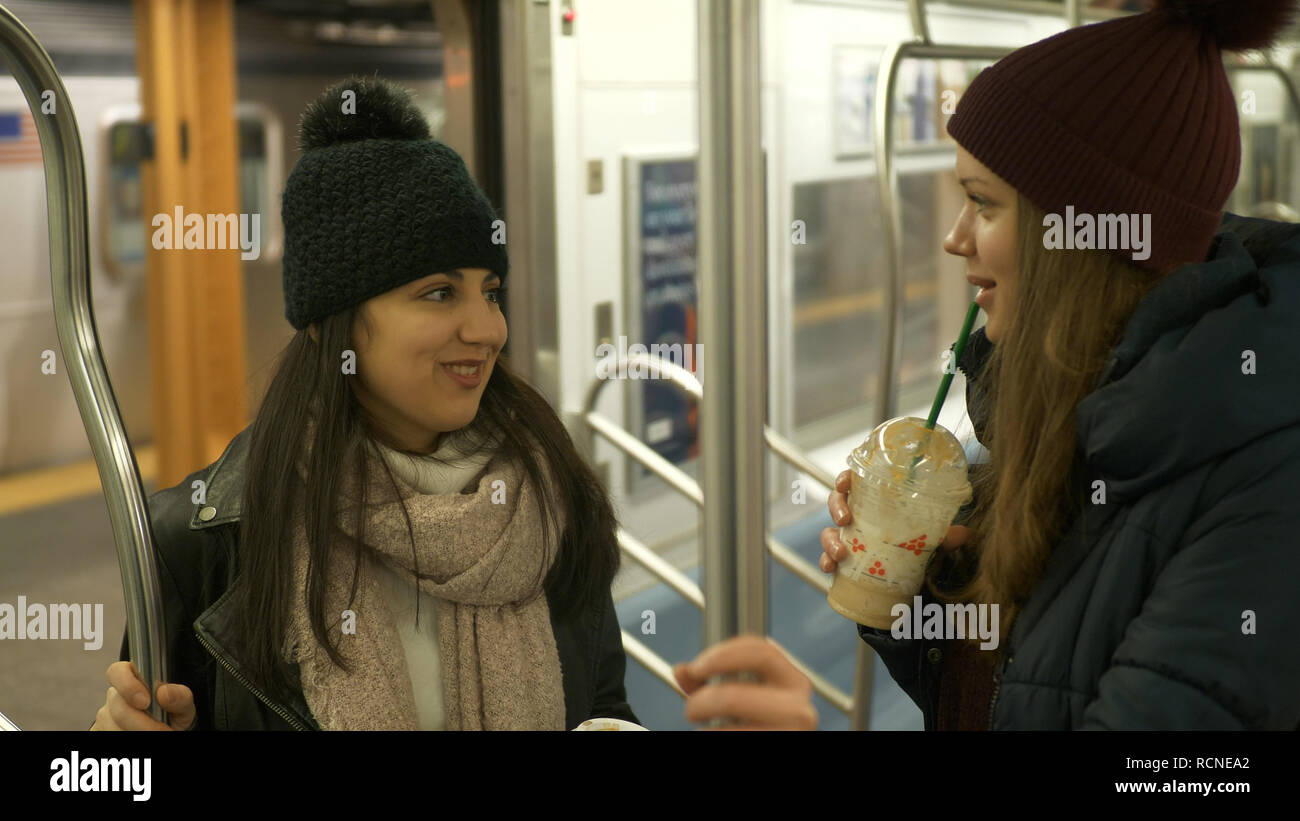 Two girls ride the New York subway Stock Photo - Alamy
