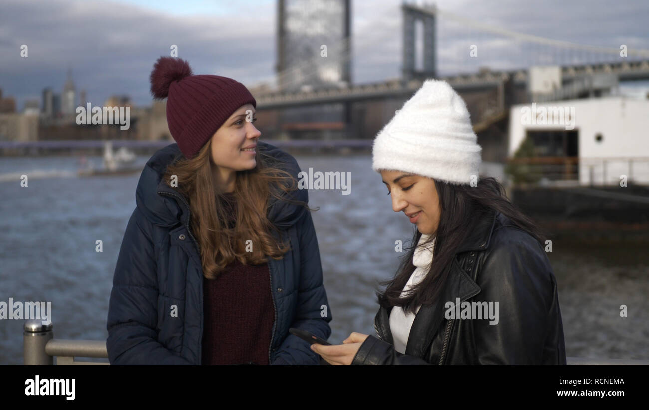 Two friends travel to New York for sightseeing at Brooklyn Bridge Stock ...
