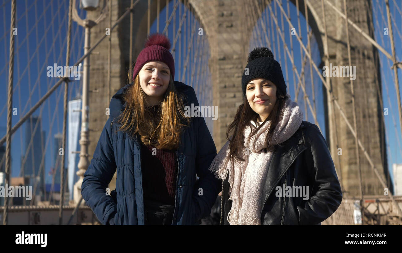 Two girls walk over the famous Brooklyn Bridge in New York Stock Photo ...