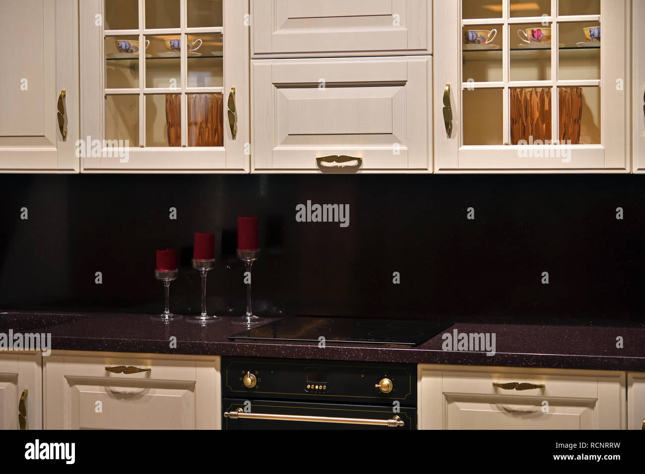 Beige kitchen set with stove in the room Stock Photo - Alamy