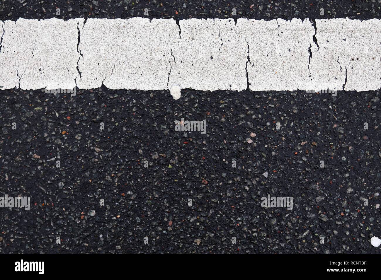 Close up high resolution surface of asphalt with stripes and cracks ...