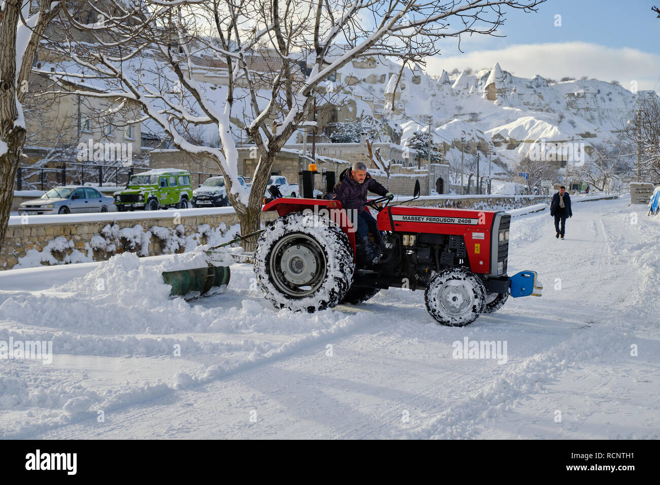 Snow clearing on street by local on a Massey Ferguson tractor with plow ...