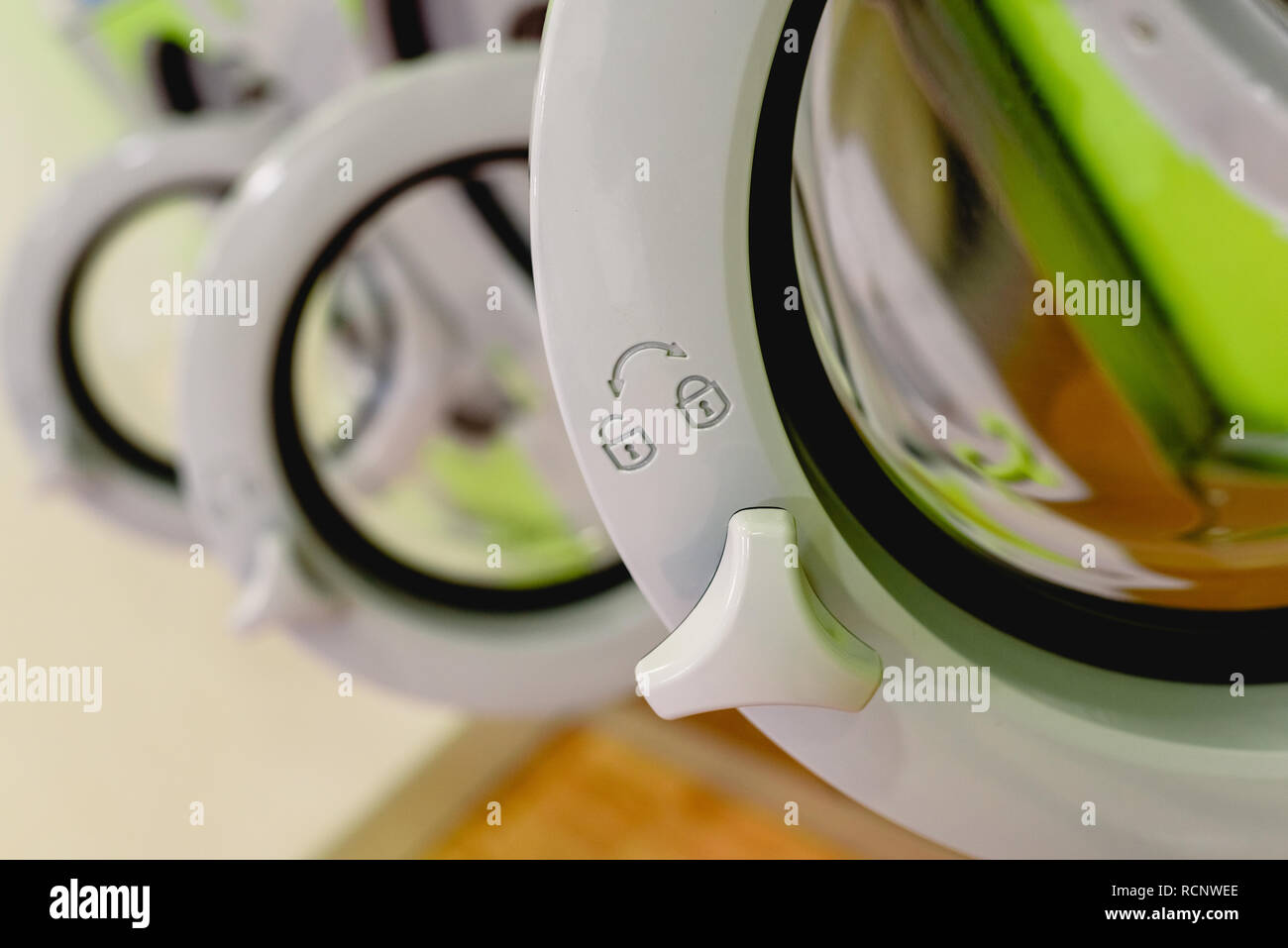 Open doors of industrial washing machines in a public laundry, door ...