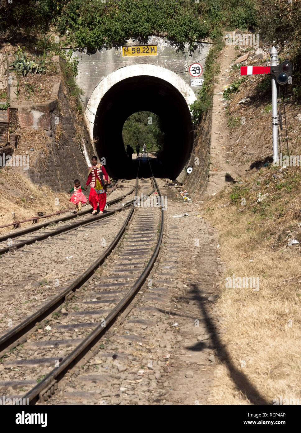Woman and child walking along railway lines Stock Photo - Alamy