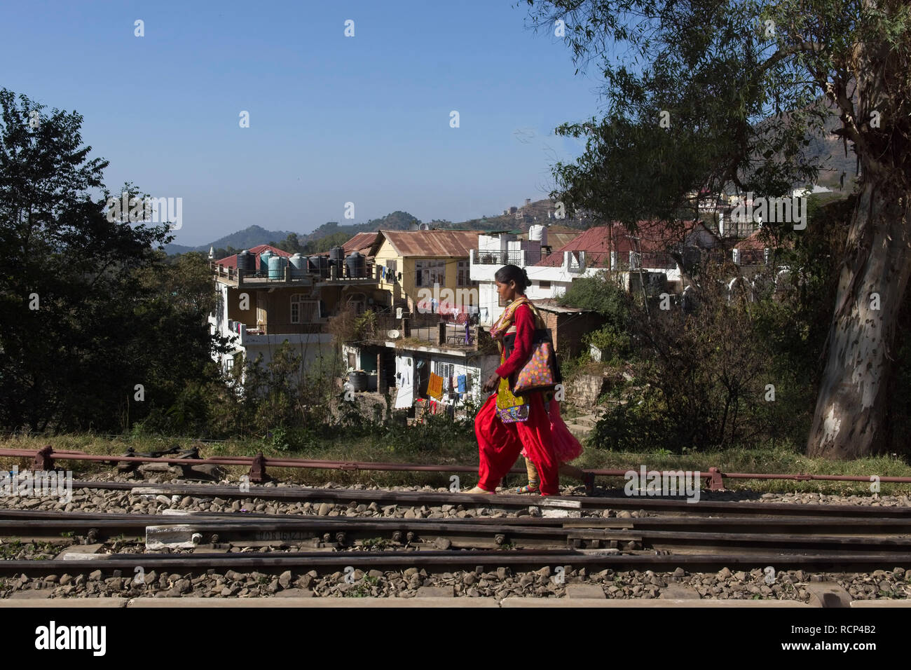 Shimla railway, Solan station, woman in red dress walking along the ...