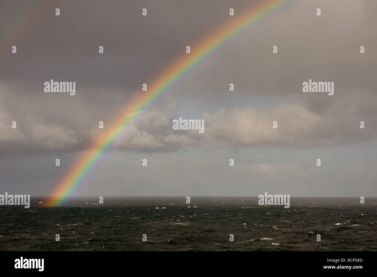 Rainbow over the ocean Stock Photo - Alamy