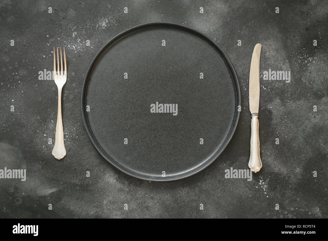 Dark table place setting on black table. Top view Stock Photo - Alamy
