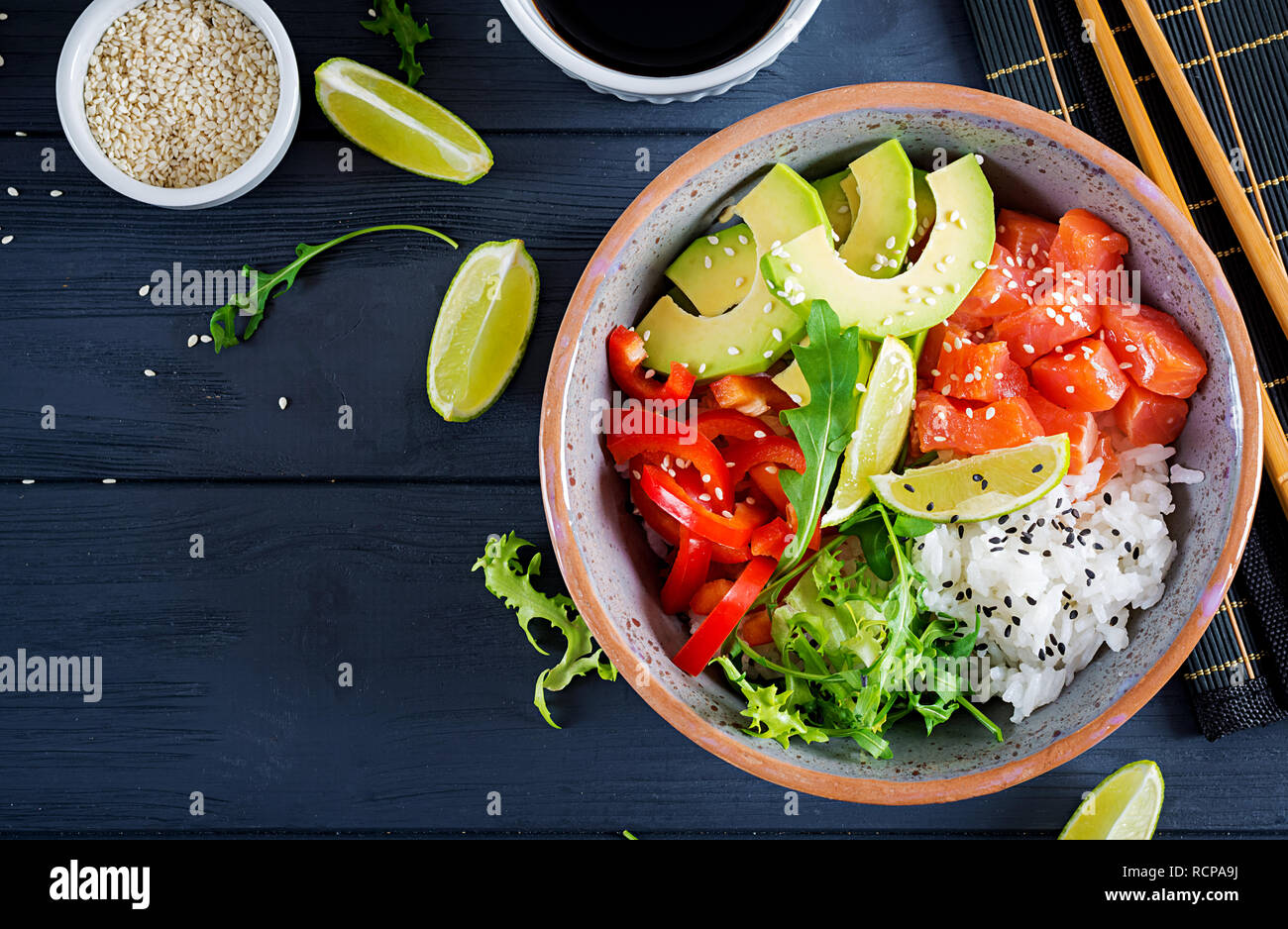Hawaiian salmon fish poke bowl with rice, avocado, paprika, sesame ...