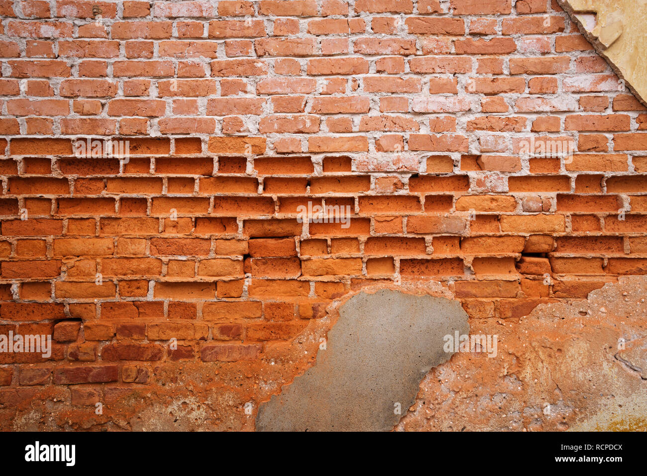 background image of old eroded plastered brick wall with most of the ...