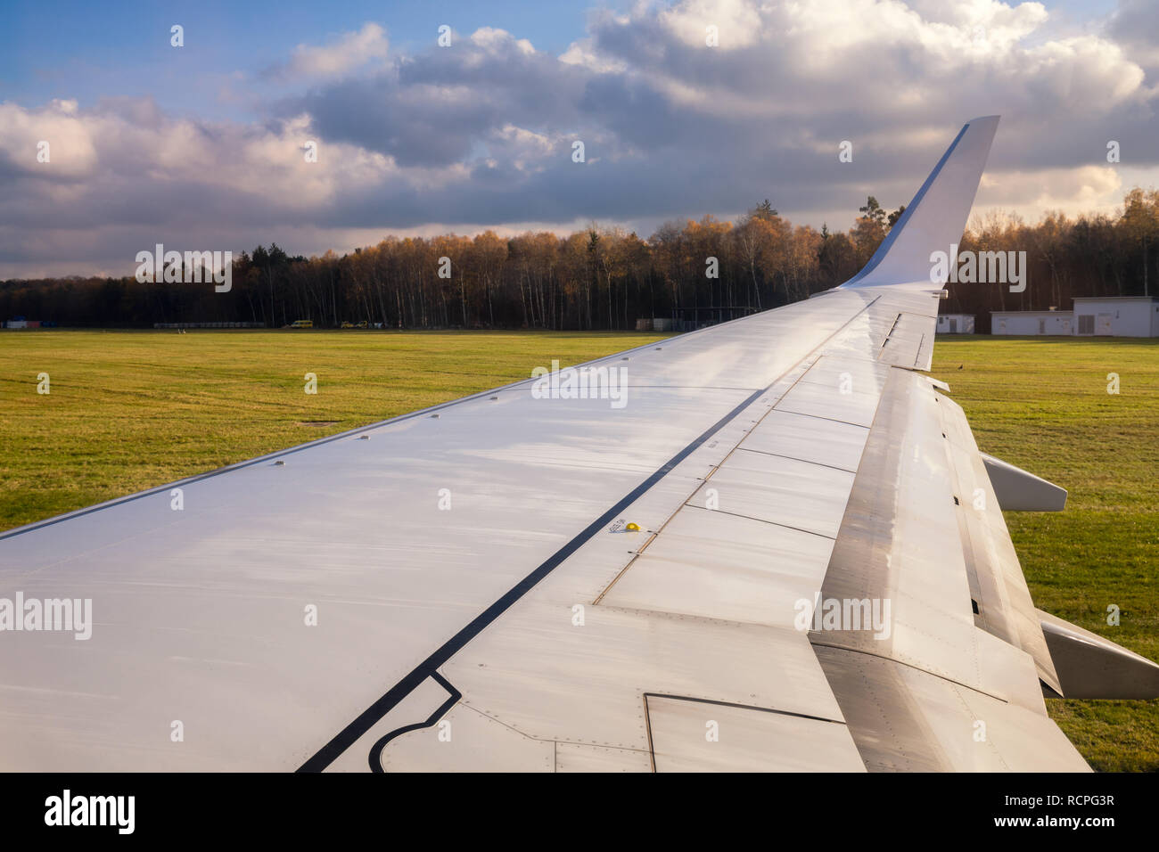Wing of the plane in the airport. View of plane wing from airplane ...