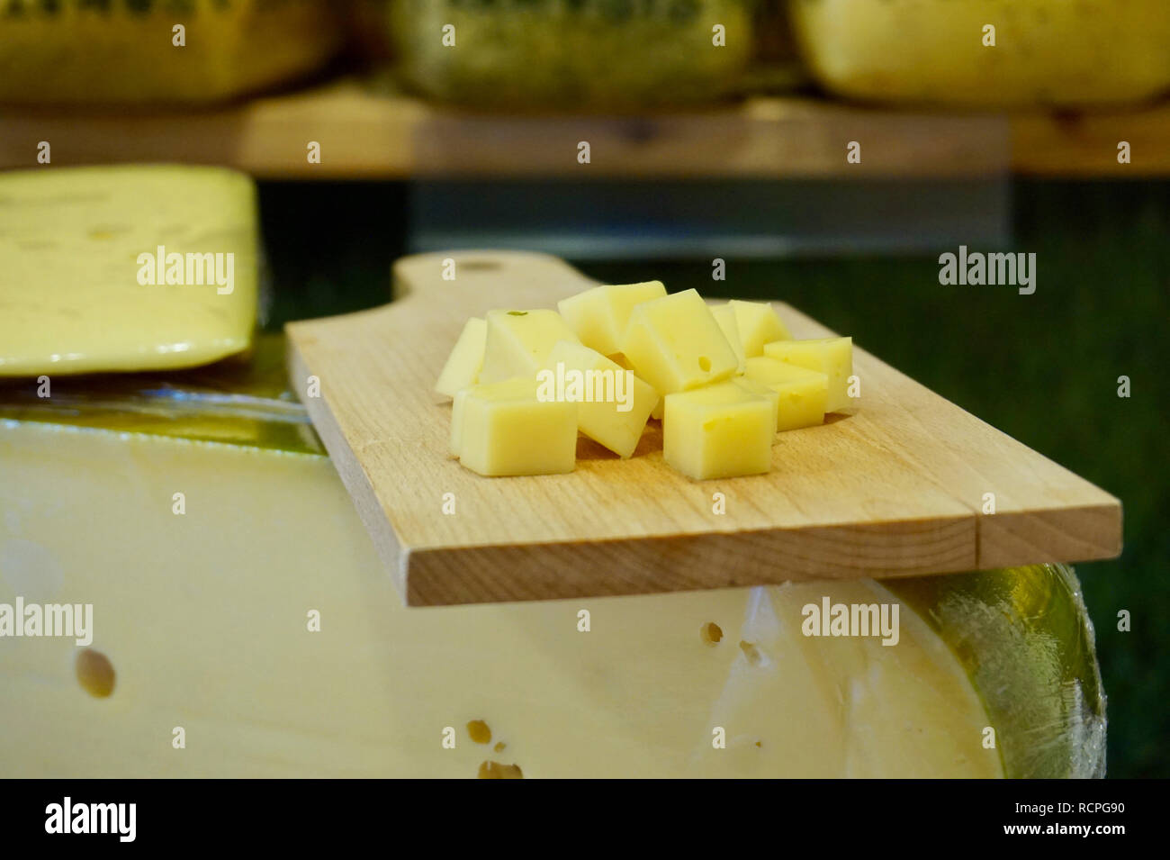Cheese cutting board with Dutch cheese cubes on top of a cheese wheel ...