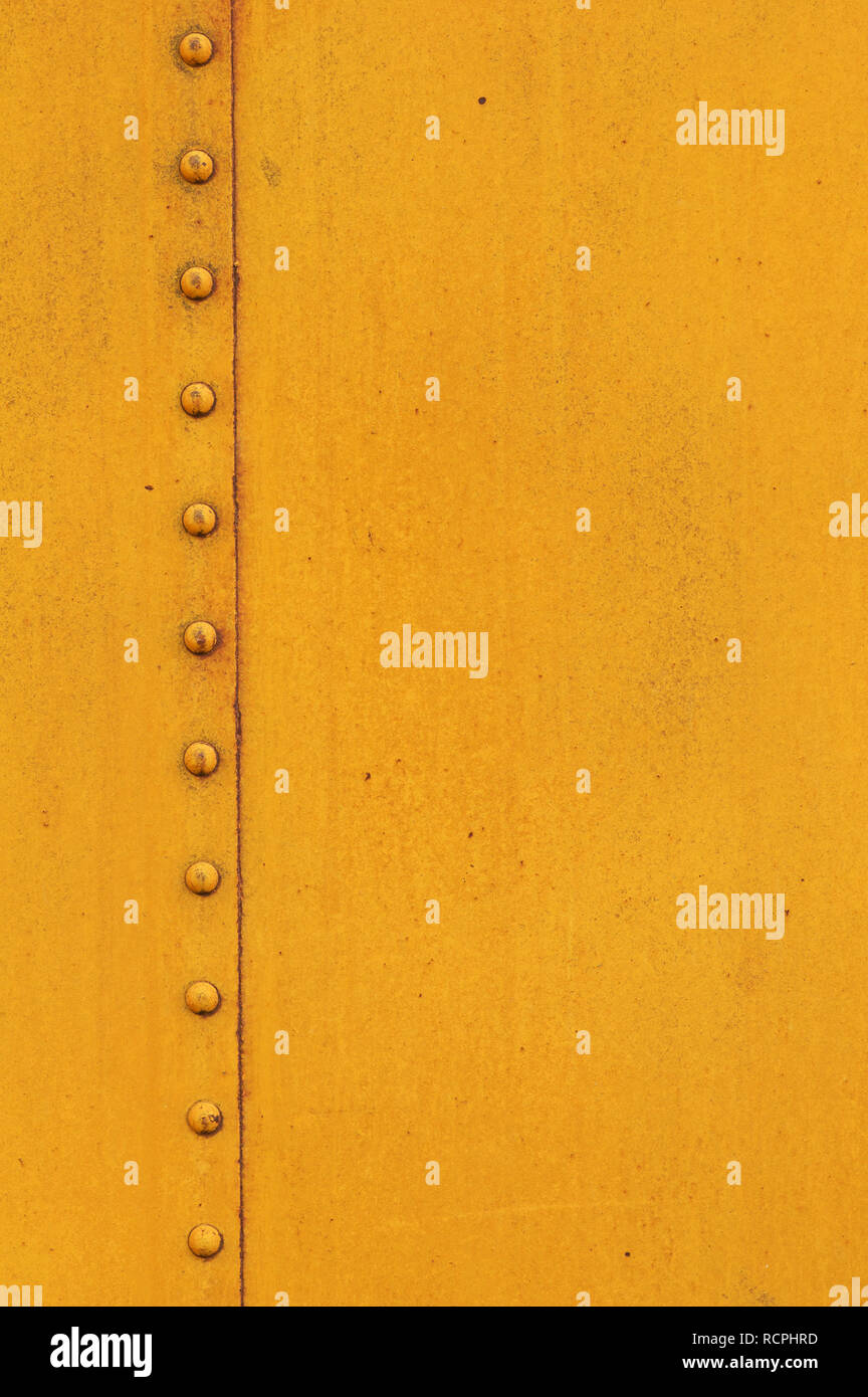 old painted yellow metal with rivet seam down one side Stock Photo - Alamy